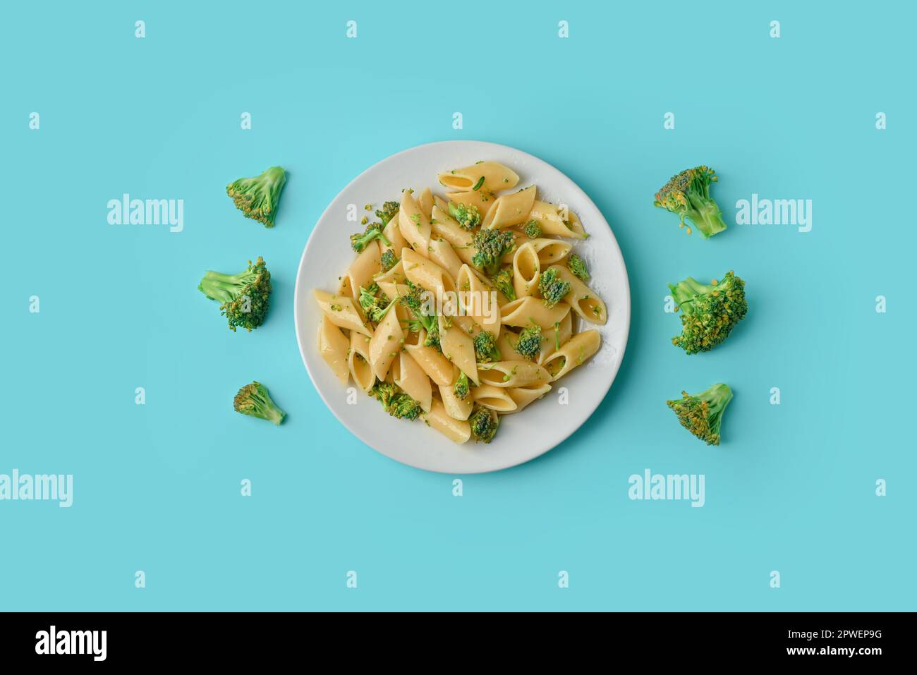 Pasta with broccoli on turquoise background Stock Photo - Alamy