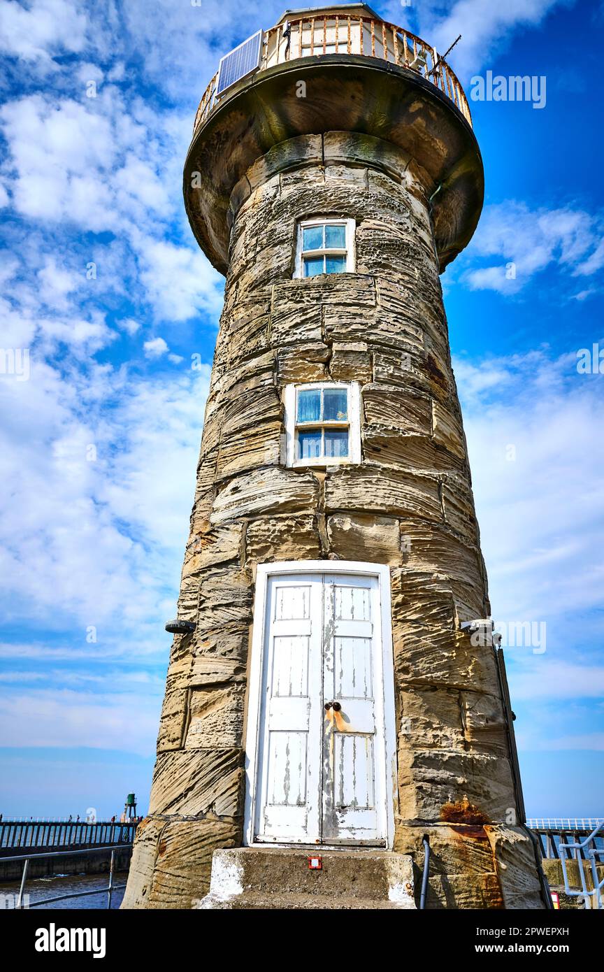 Old stone built lighthouse on Whitby harbour seawall Stock Photo - Alamy