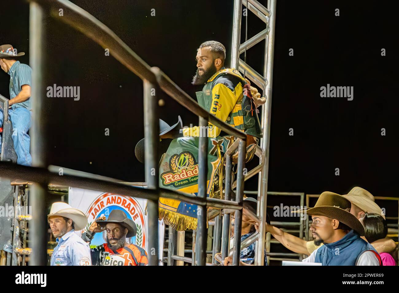 Itaja, Goias, Brazil - 04 22 2023: Cowboy sitting on the railings of ...