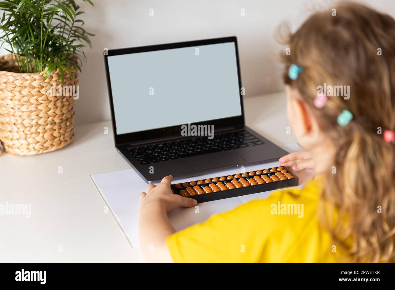 A girl from the back is engaged in mental arithmetic on the abacus ...