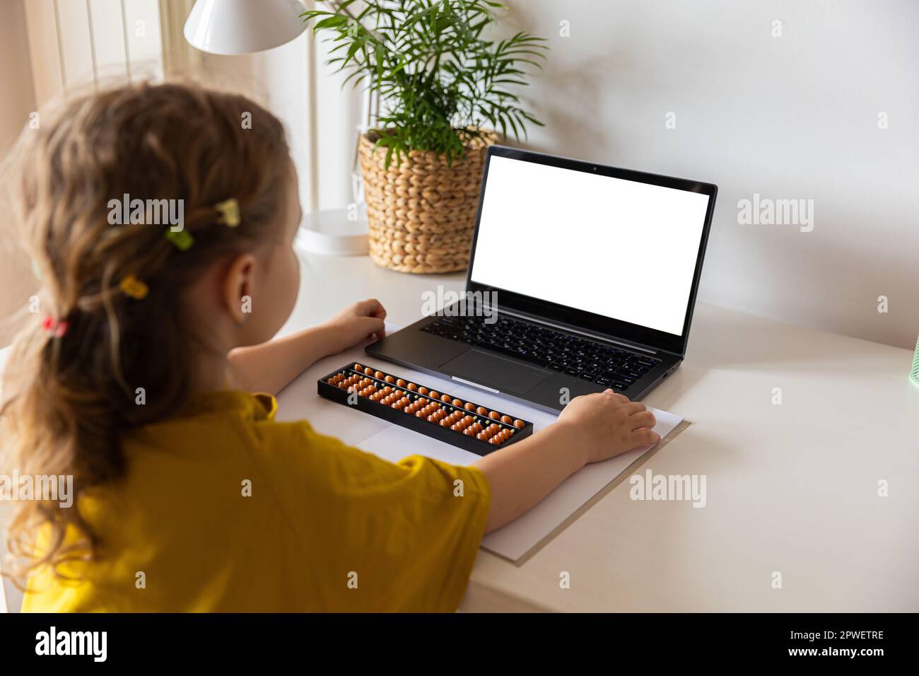 A girl from the back is engaged in mental arithmetic on the abacus ...