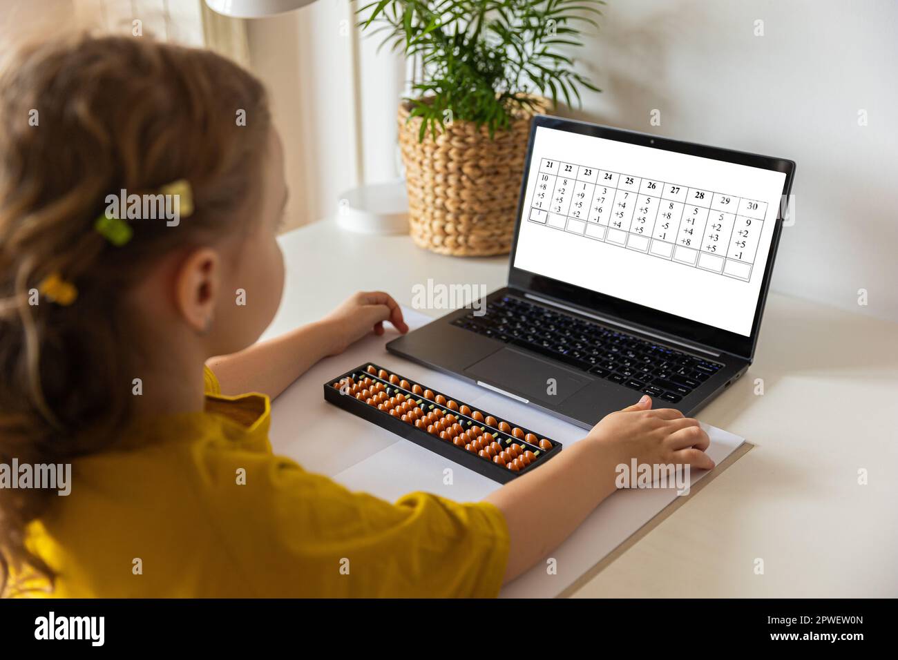 A girl from the back is engaged in mental arithmetic on the abacus ...