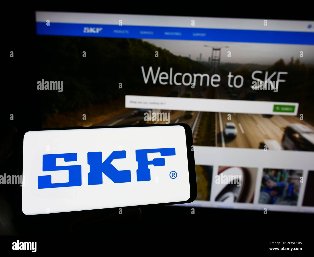 Person holding smartphone with logo of Swedish bearing manufacturing ...