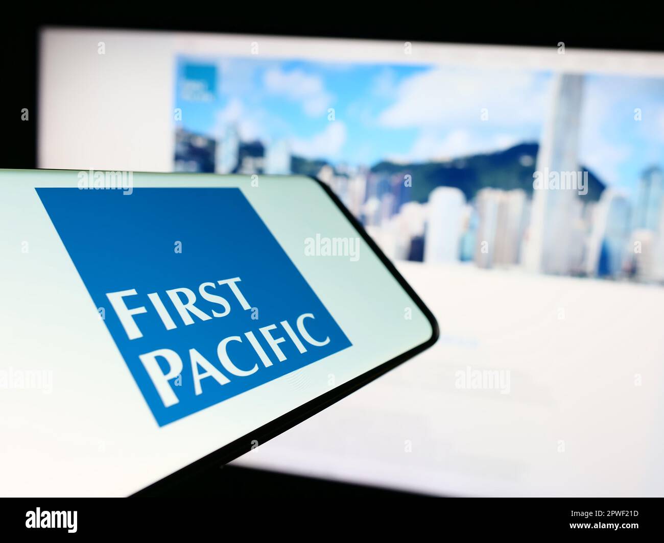 Mobile phone with logo of investment firm First Pacific Company Limited ...