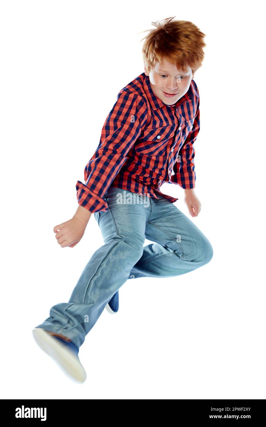 Hes got all the right moves. Studio shot of a young boy jumping ...