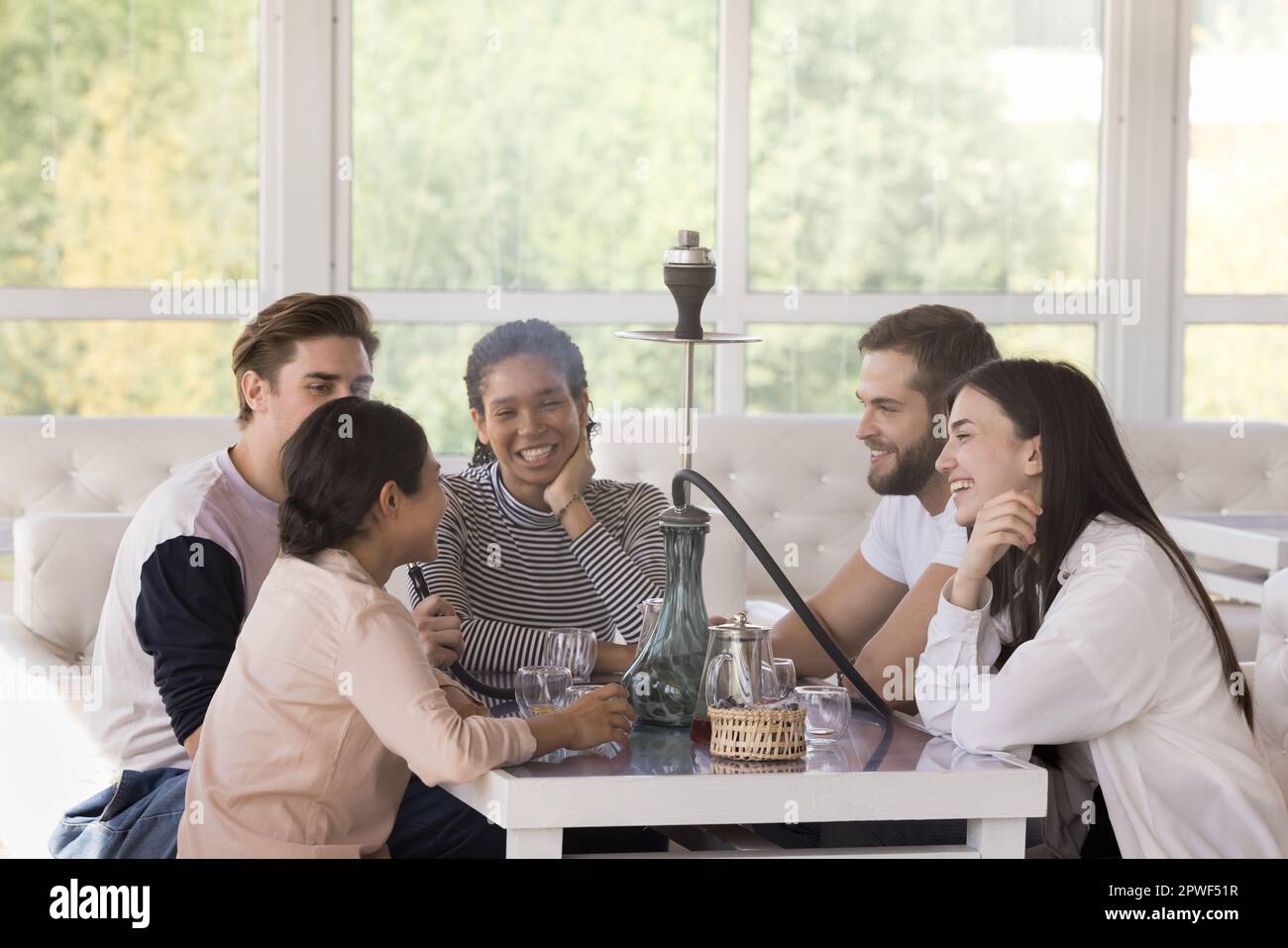 Group of friends smoking shisha, hanging out together Stock Photo - Alamy