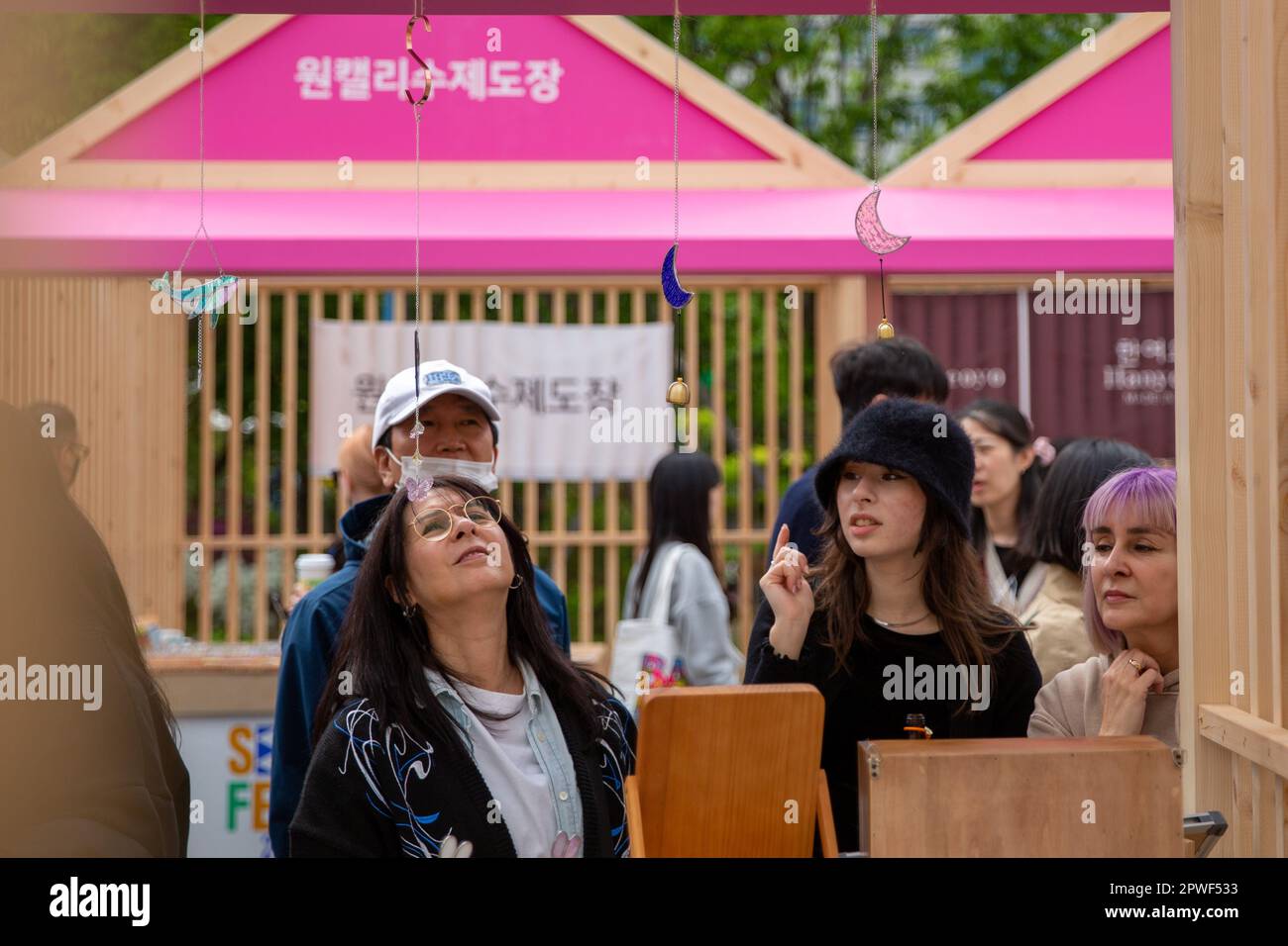 Seoul, South Korea. 30th Apr, 2023. Visitors look at wind chimes at the ...