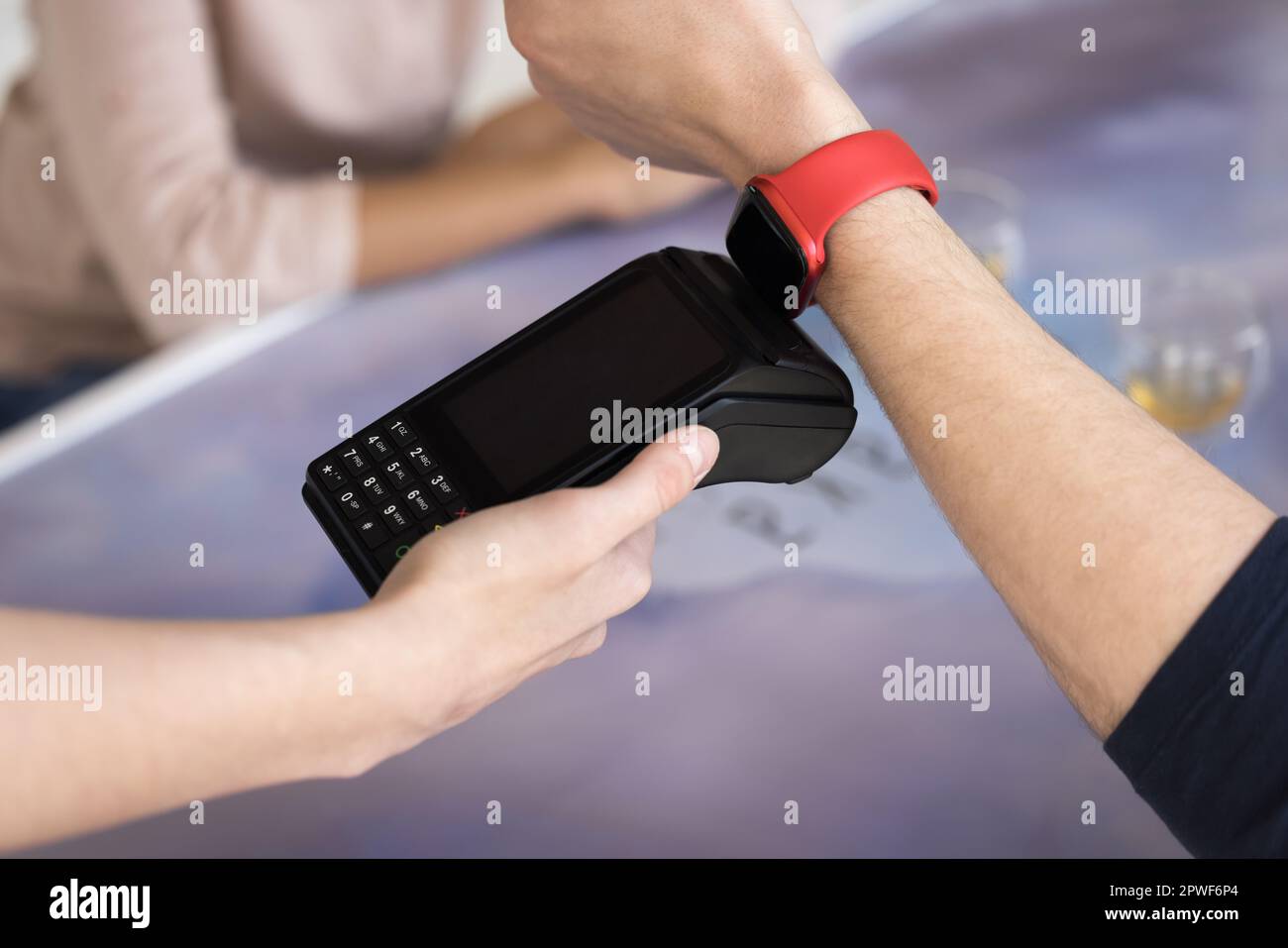 Closeup guy paying bill, apply smartwatch on POS terminal machine Stock ...