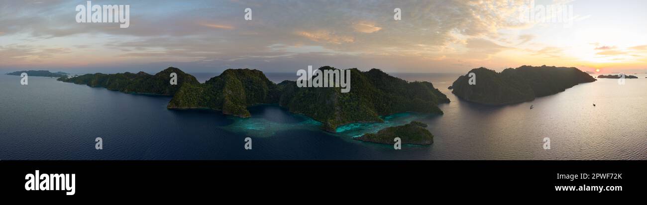 Sunrise illuminates dramatic limestone islands that rise from Raja ...