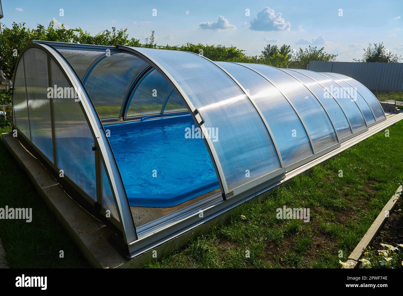 Outdoor swimming pool with sliding cover. Weather protection Stock ...