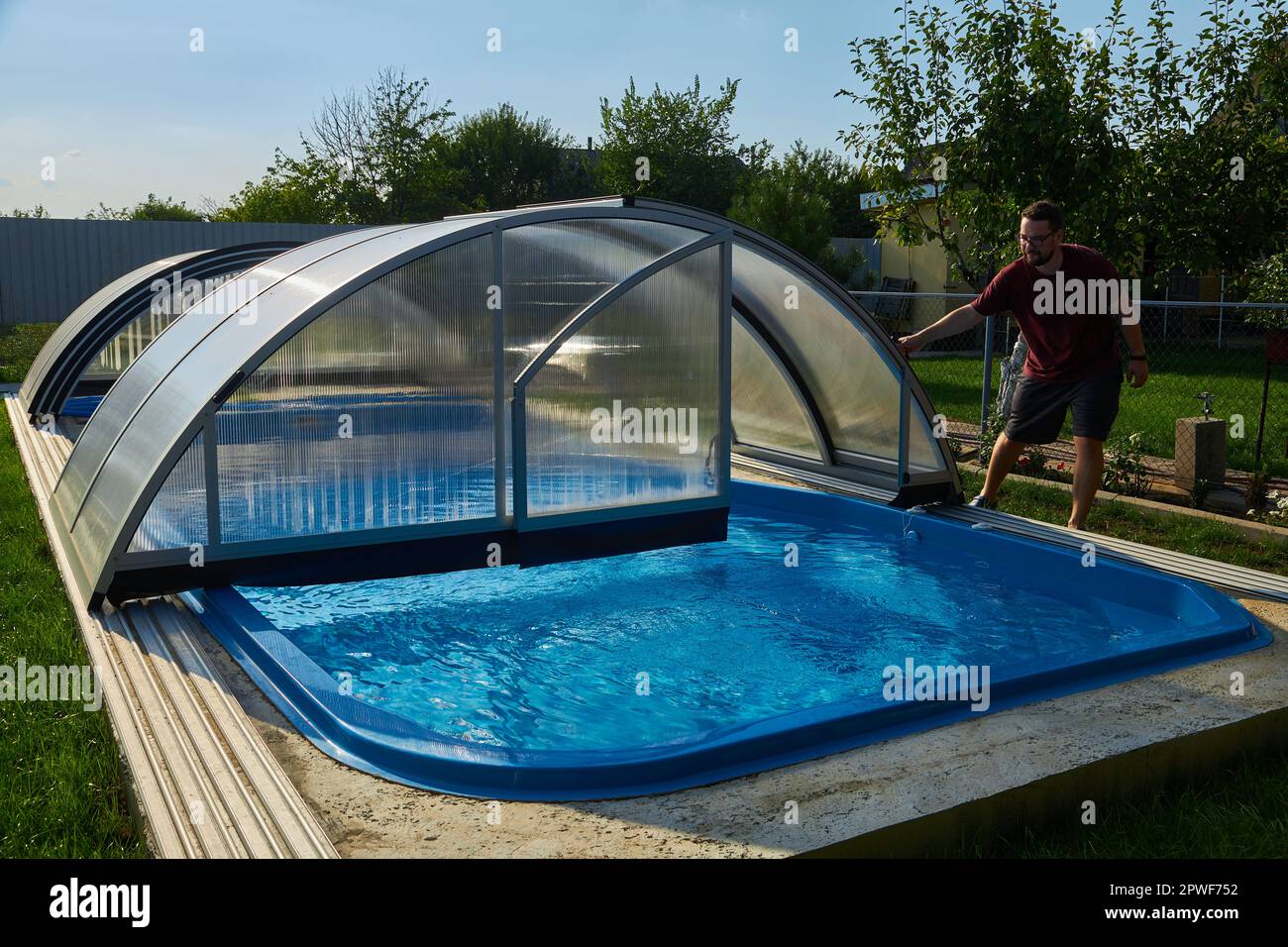 Outdoor swimming pool with sliding cover. Weather protection Stock ...