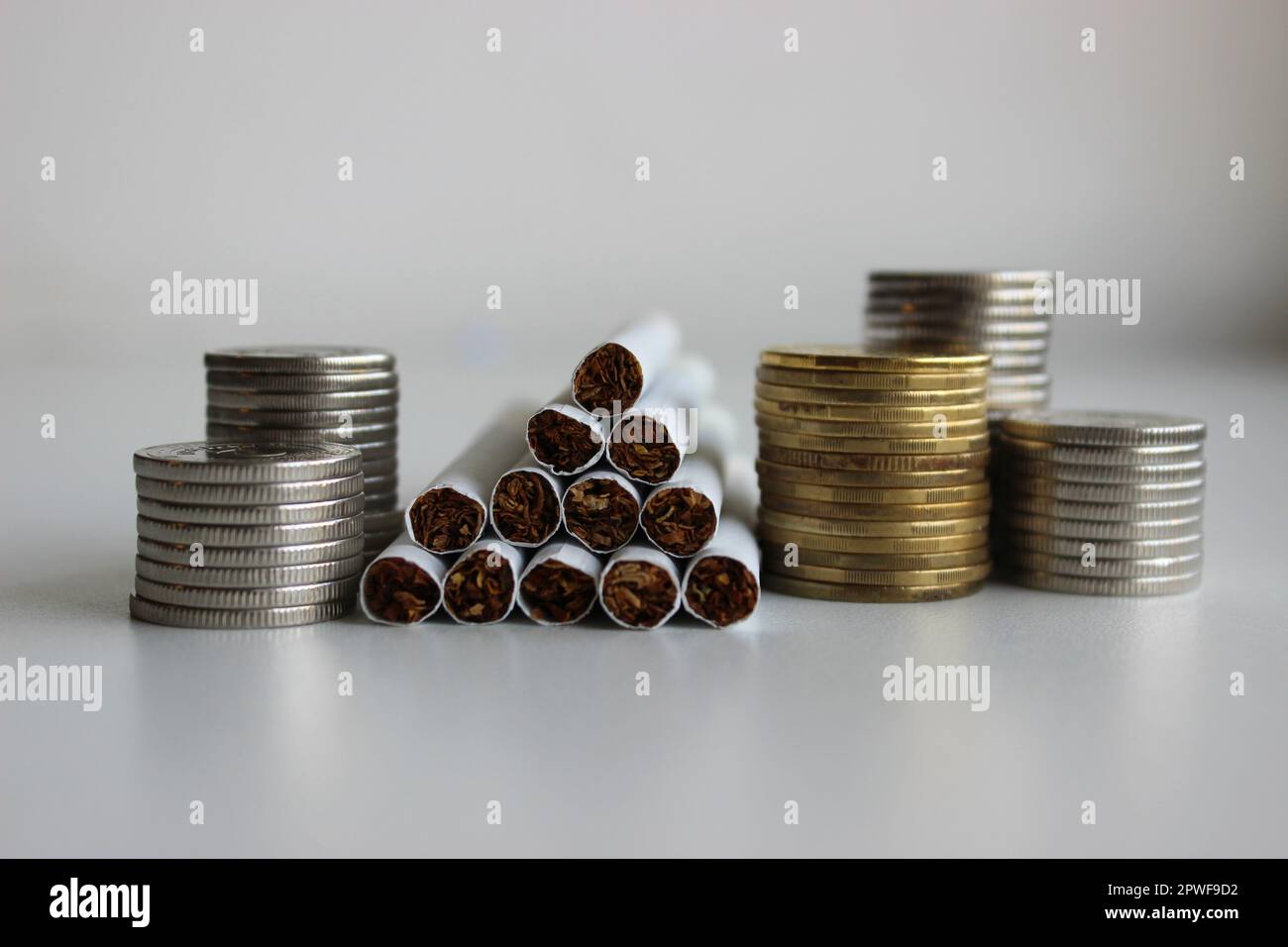 Cigarettes are lined with a slide between the columns of coins front ...