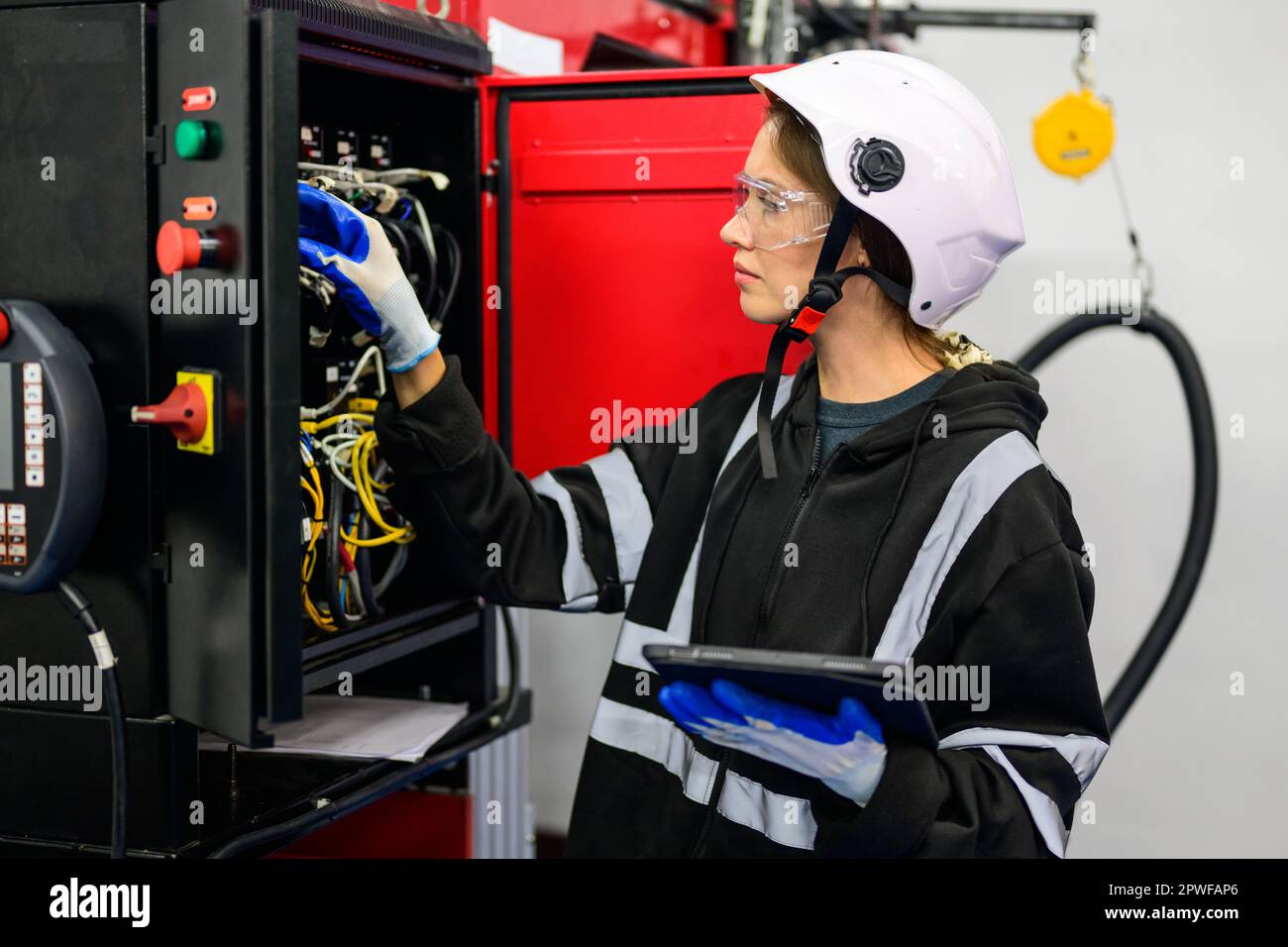 Young technician checking and repairing part of automatic machine Stock ...