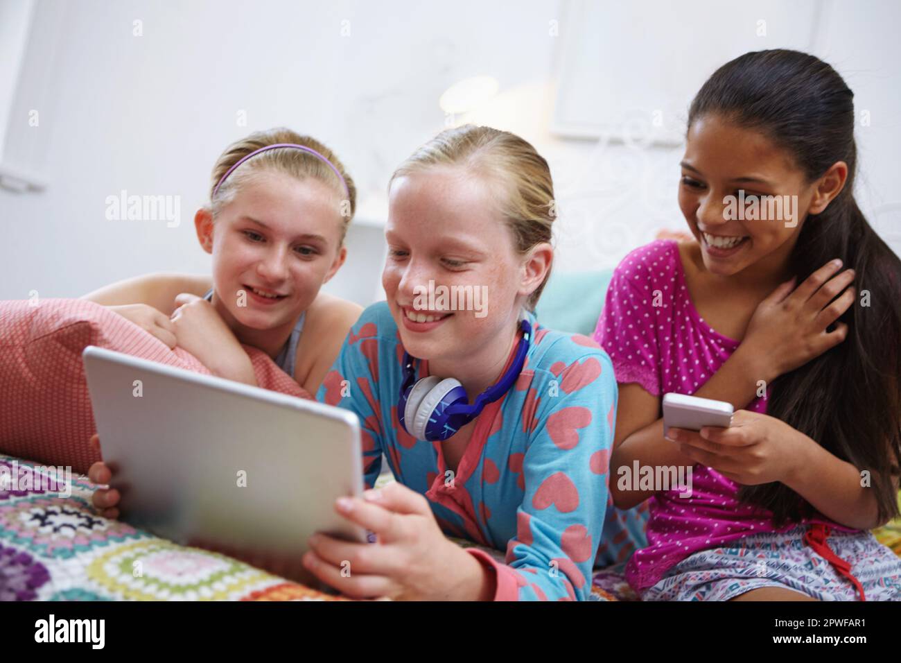 Teens and technology. a group of teenage friends using a digital tablet ...