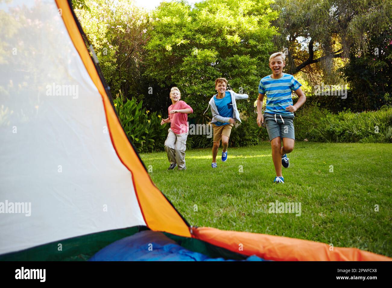 Camping fun and friendship. Full length shot of three young boys ...