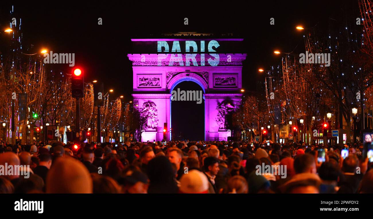 Paris, France - January 1st, 2023 : Crowd gathered on the Champs ...