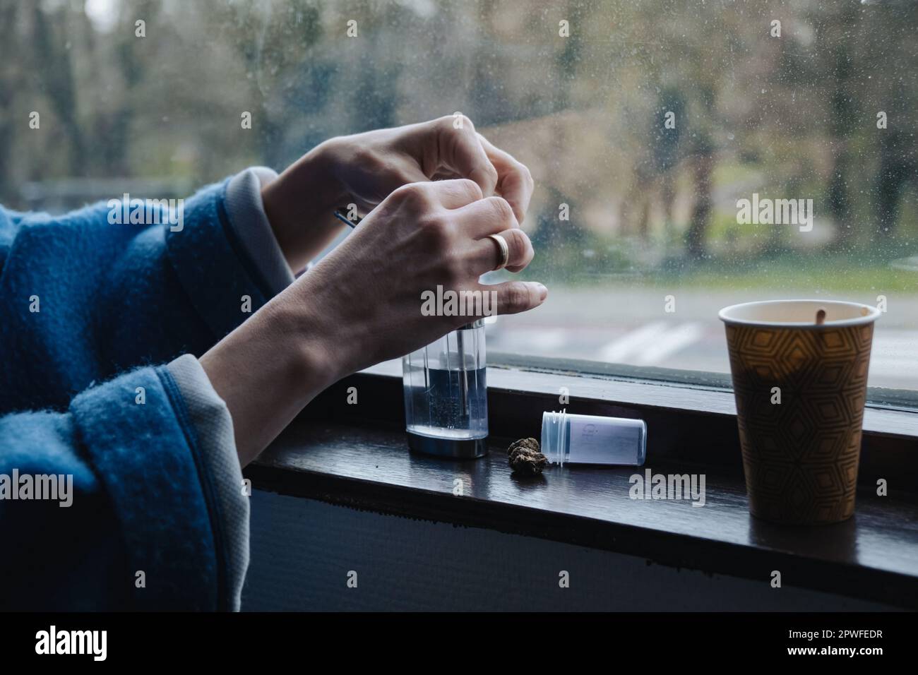 Woman smoking by window hi-res stock photography and images - Alamy