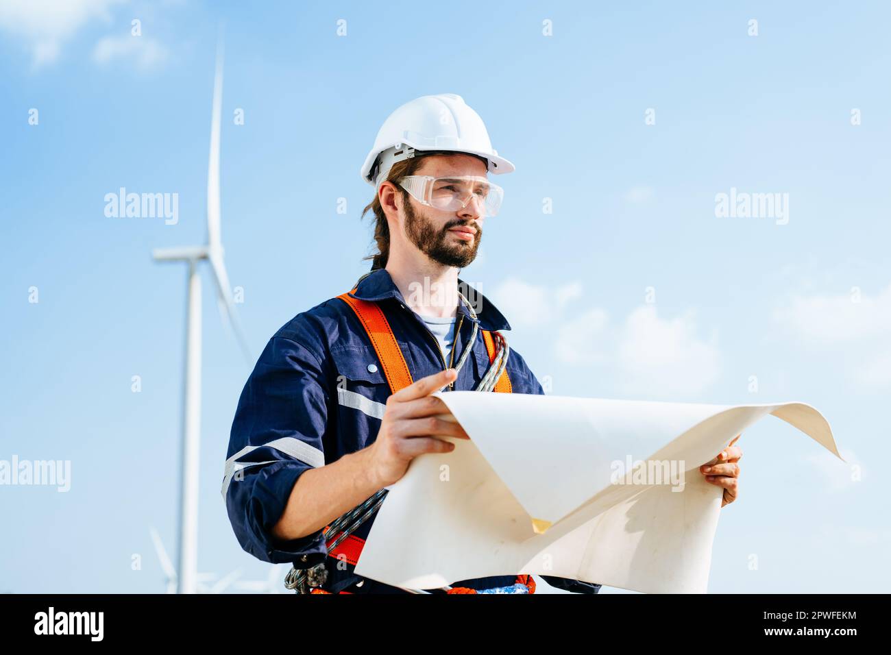 Professional maintenance engineer working at wind turbine farm Stock ...