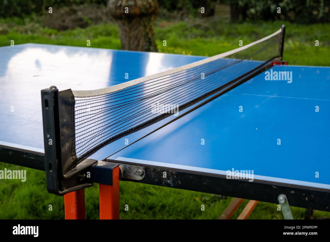 Ping pong table on green grass. Folding table for playing small tennis ...