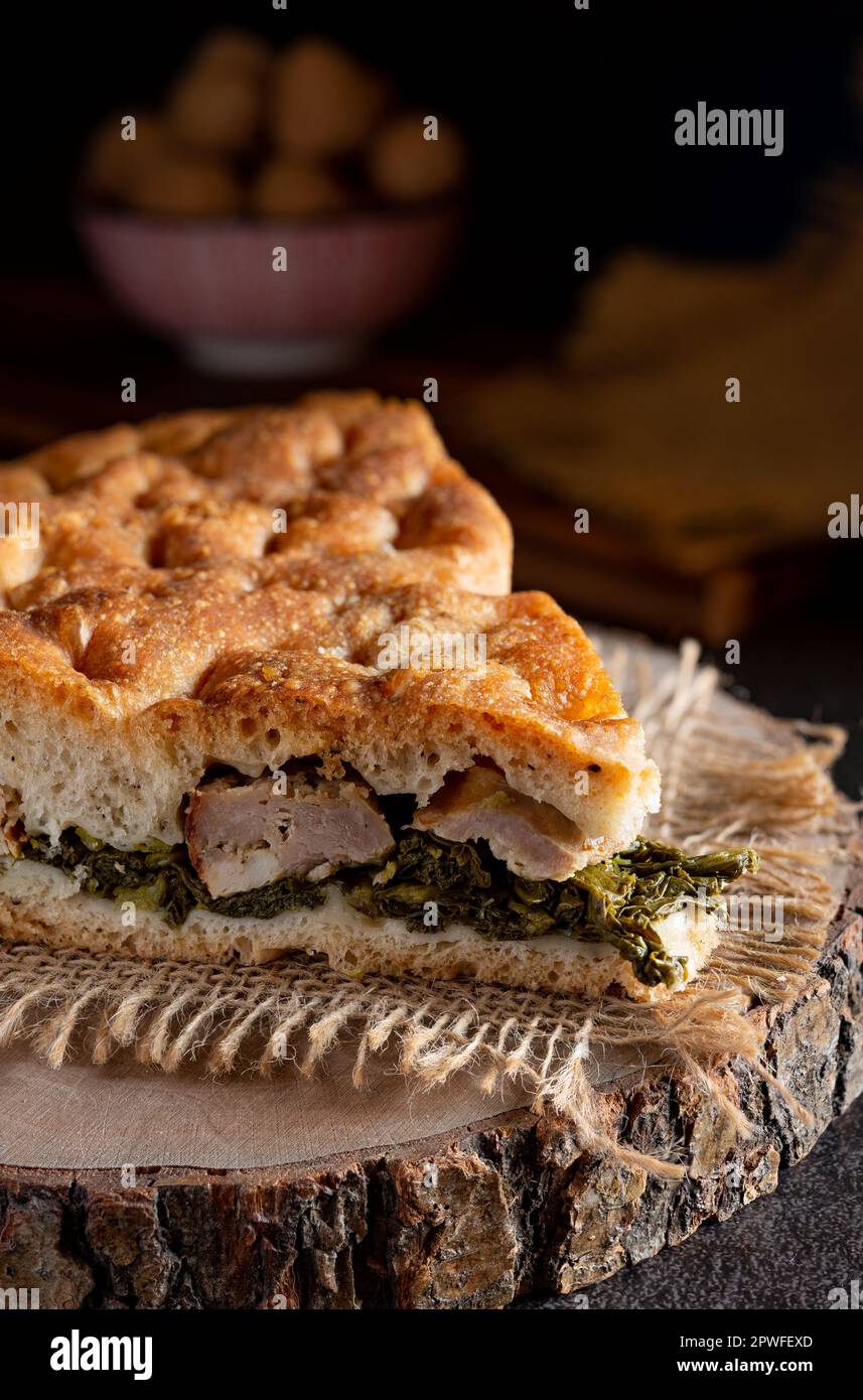 slice of Neapolitan homemade pizza with pork sausages and friarielli ...