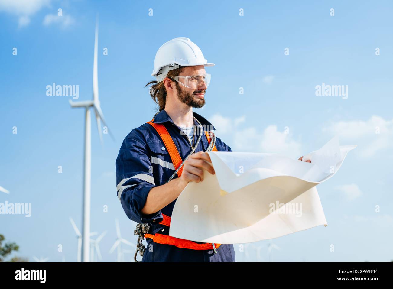 Professional maintenance engineer working at wind turbine farm Stock ...