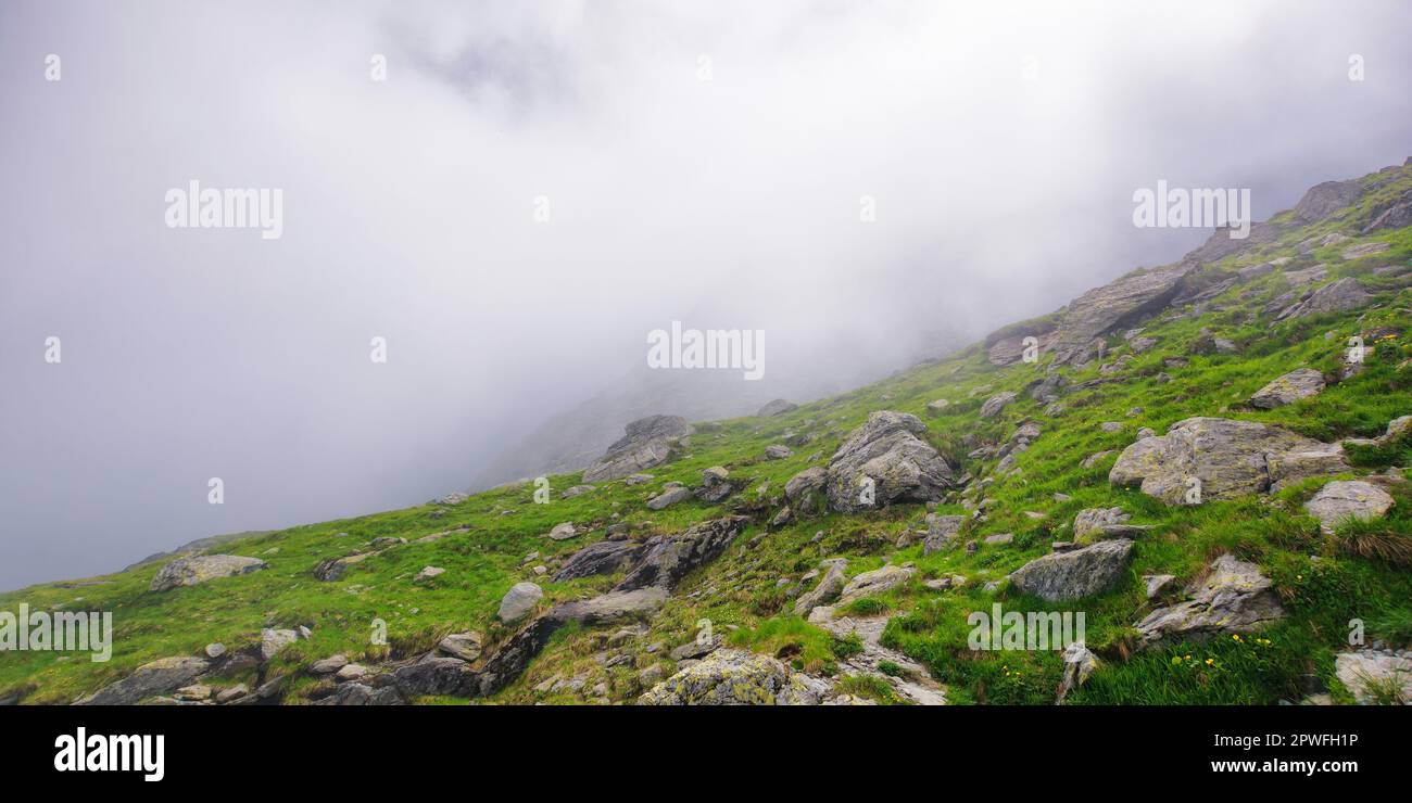 steep slopes of fagaras mountains, romania. rocks and boulders among ...