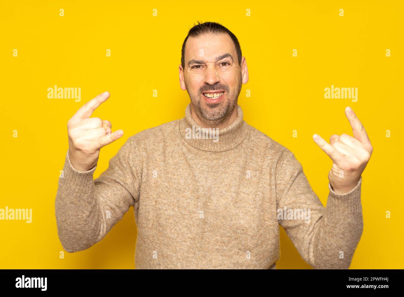 Photo of excited funky guy dressed in beige turtleneck sweater showing ...