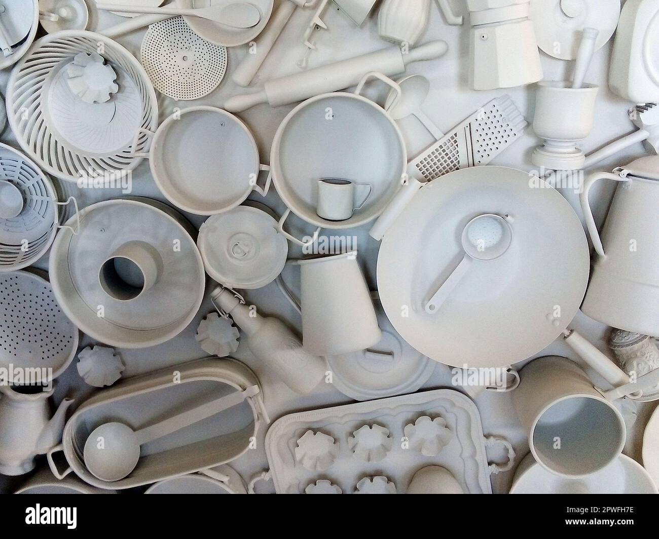 White painted kitchen utensils decorating the wall Stock Photo - Alamy