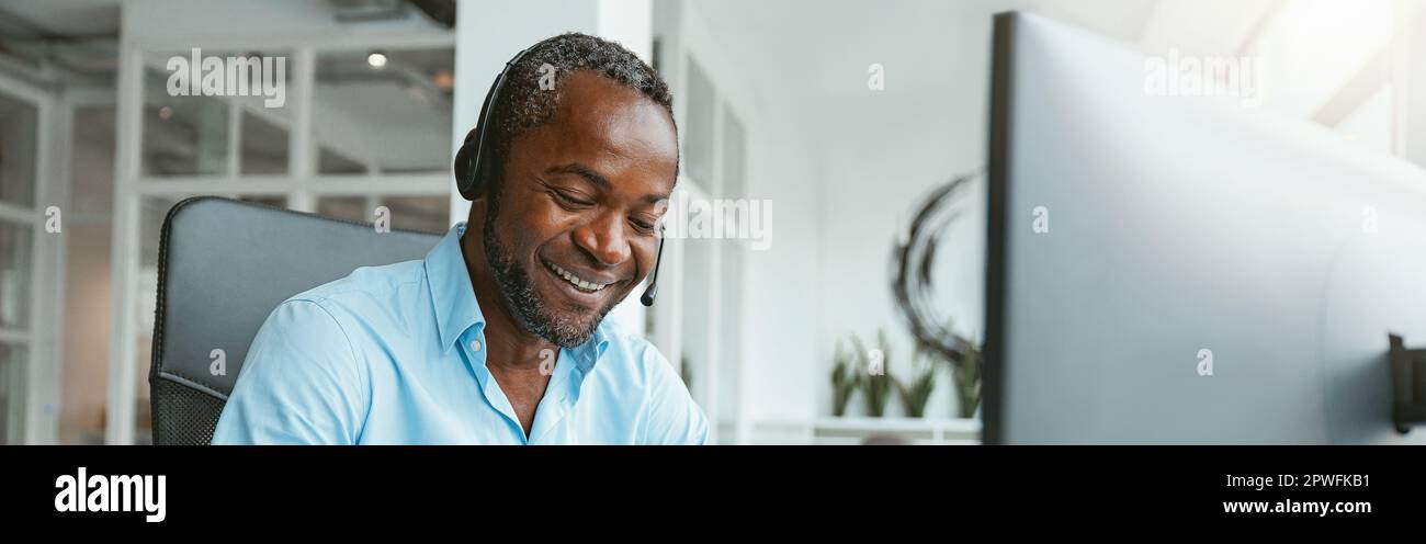 Smiling African businessman taking while working on computer in modern office Stock Photo - Alamy