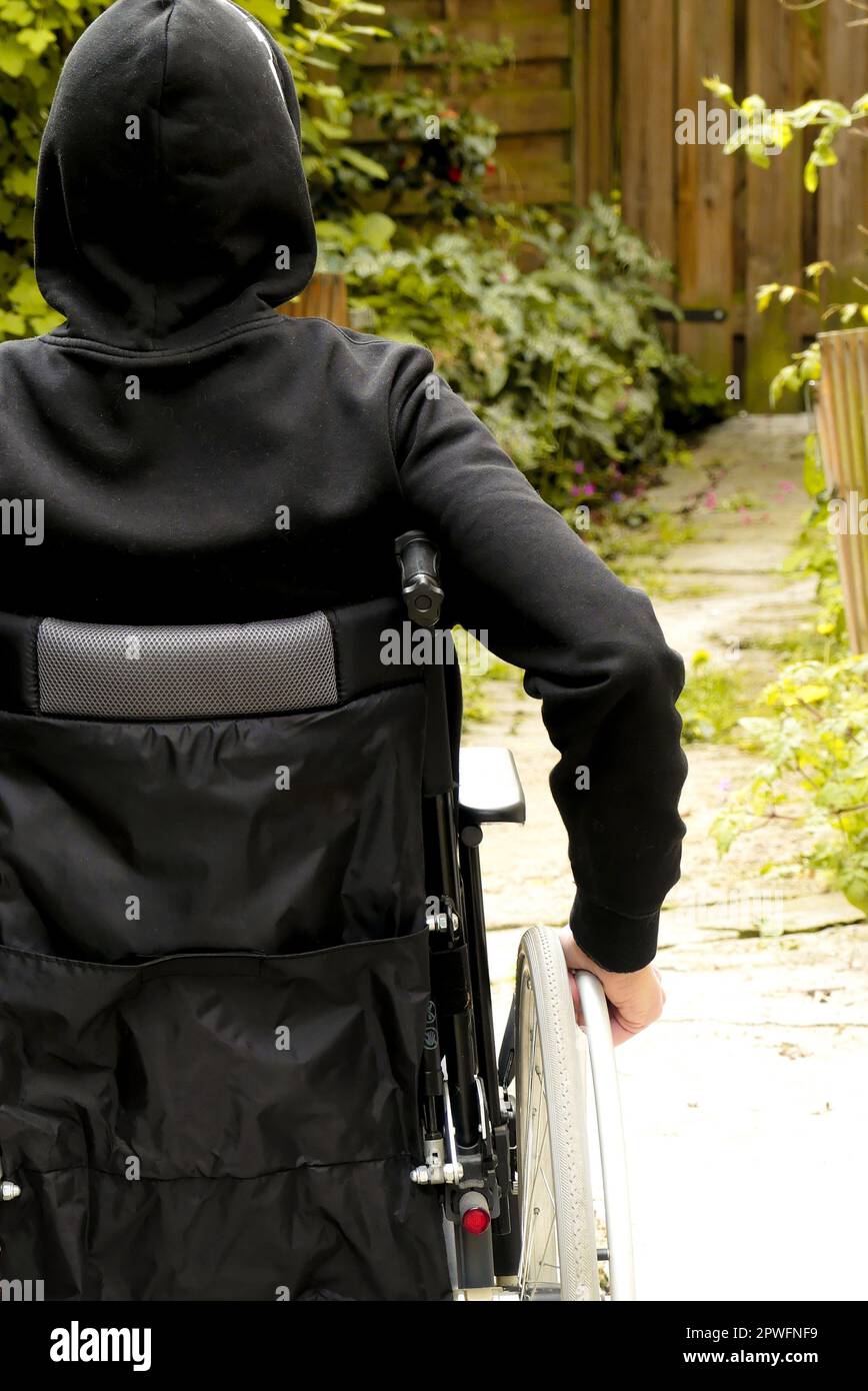 A disabled person in a wheelchair. A man with reduced mobility in an ...