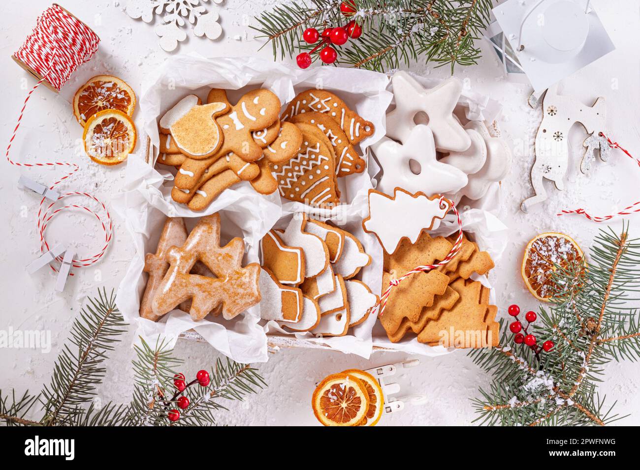 Top view of unpacked christmas present with sweets on a white textured ...