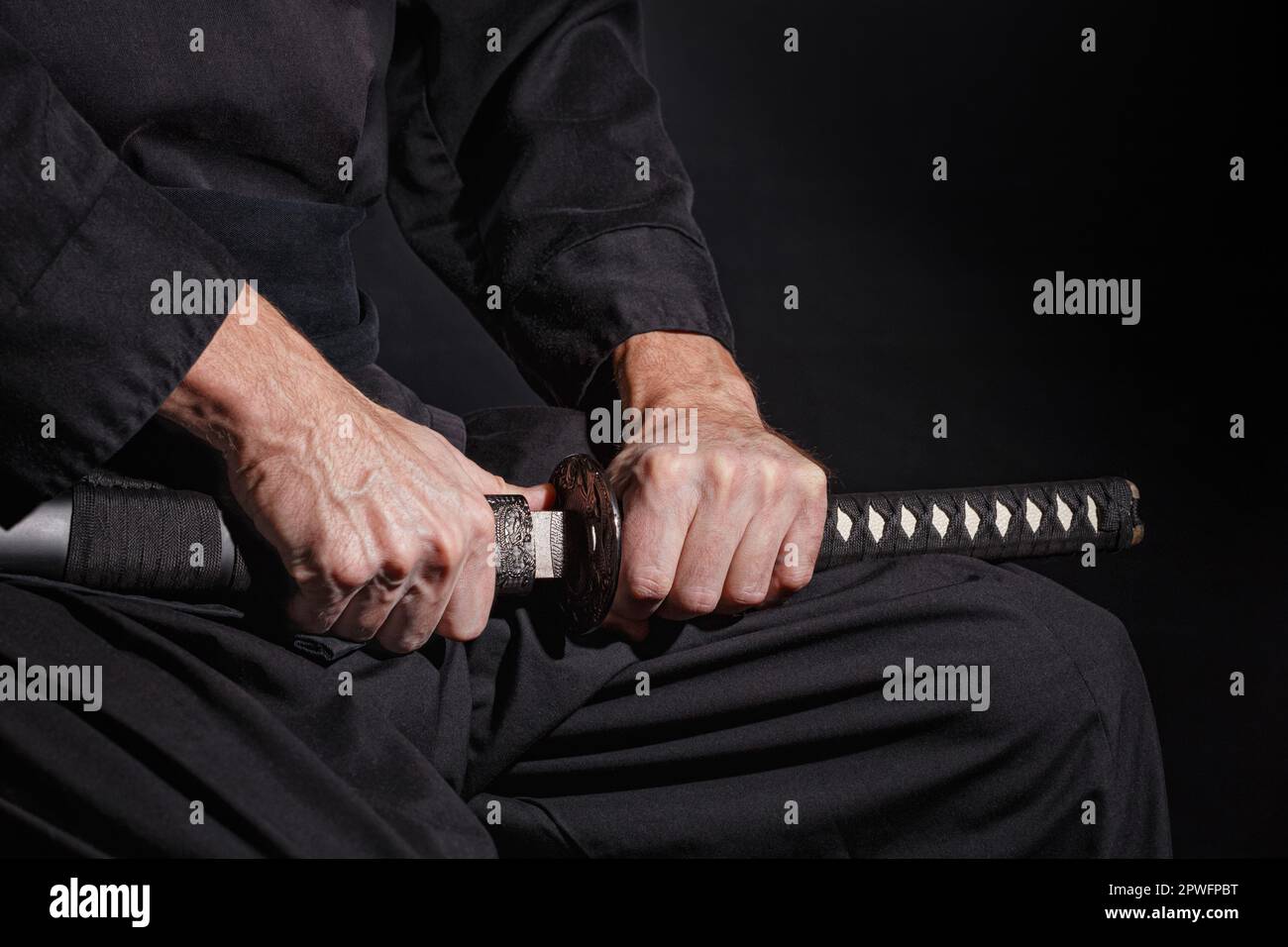 The samurai holding a Japanese katana sword. Photo of a warrior dressed ...
