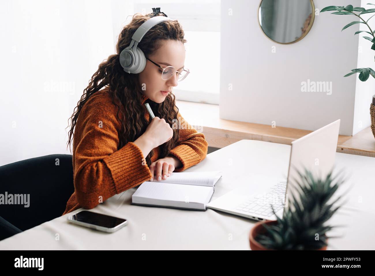 Young woman elearning from home, attending virtual class and remote ...
