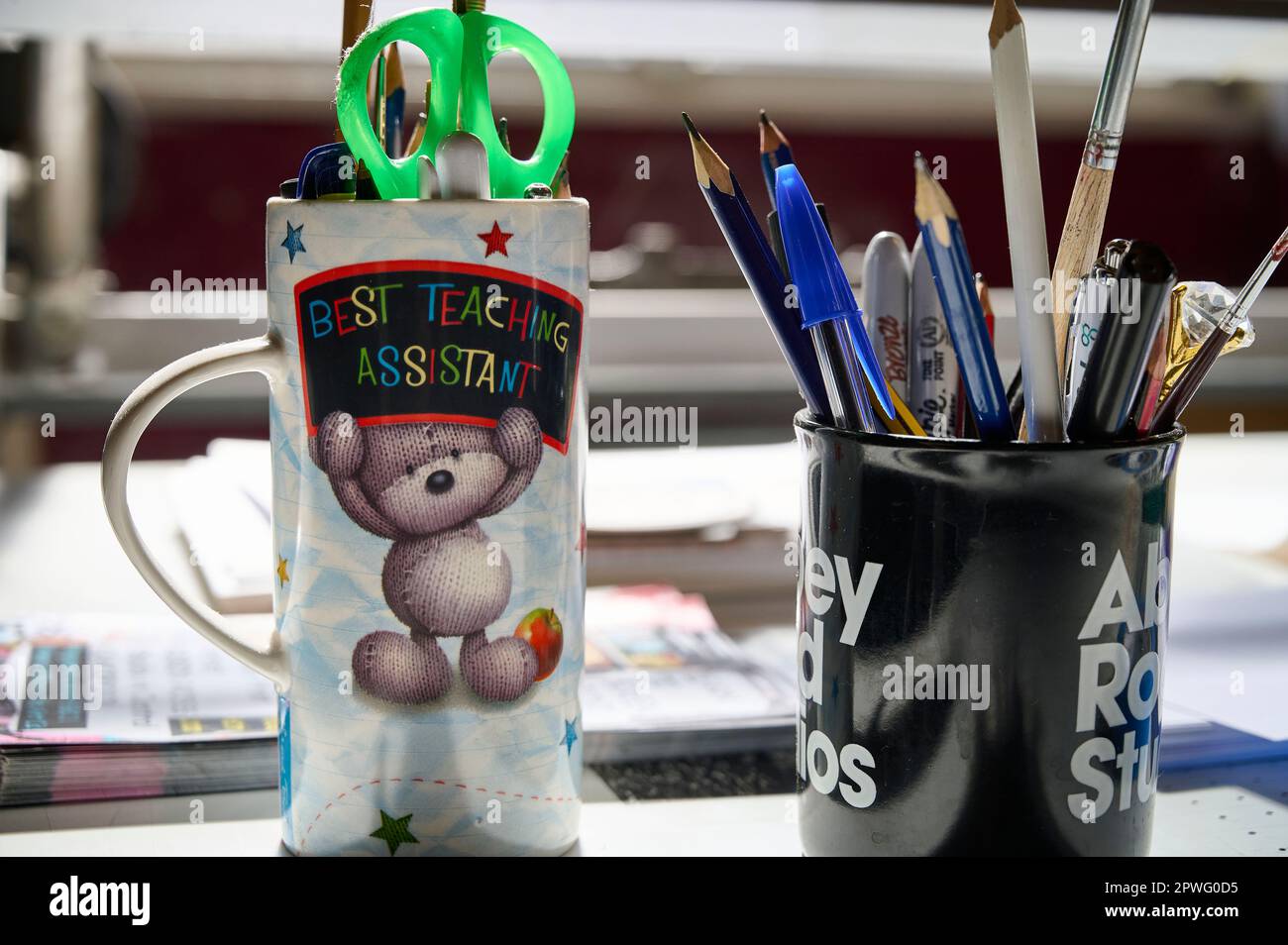Containers holding pencils, pens and scissors in art studio Stock Photo ...