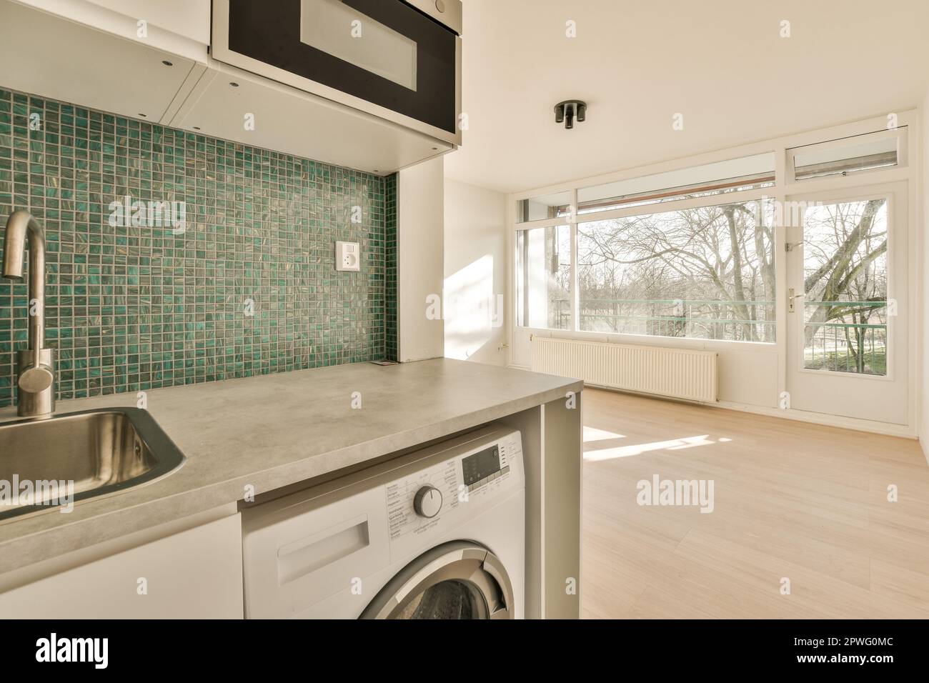 a laundry room with a washer and dryer on the floor in front of an open ...