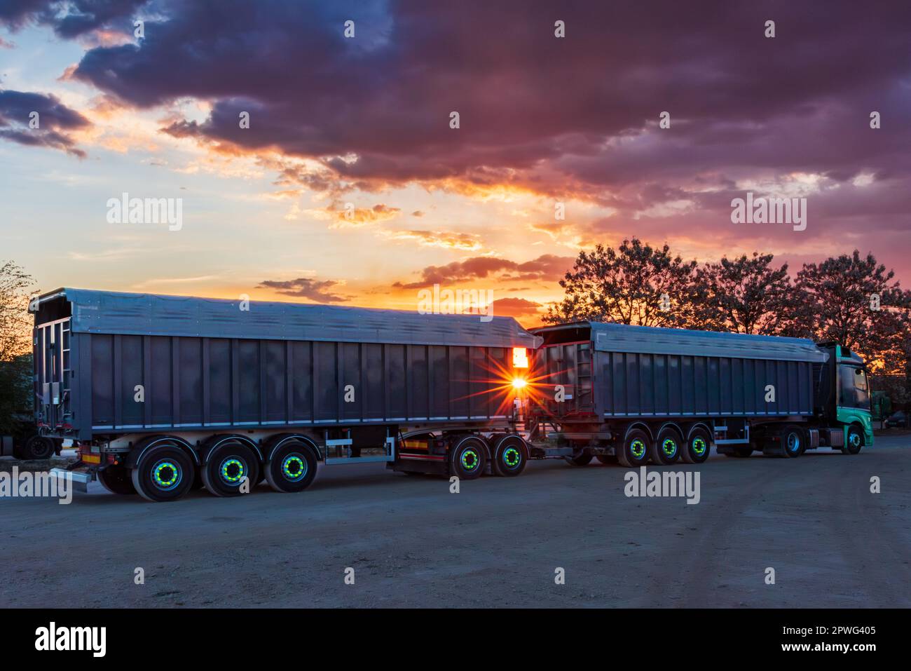 Duo-trailer with tippers for scrap metal parked at sunset Stock Photo ...