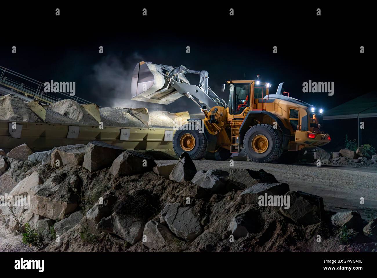 Heavy construction and mining machinery unloading gravel into silos on ...