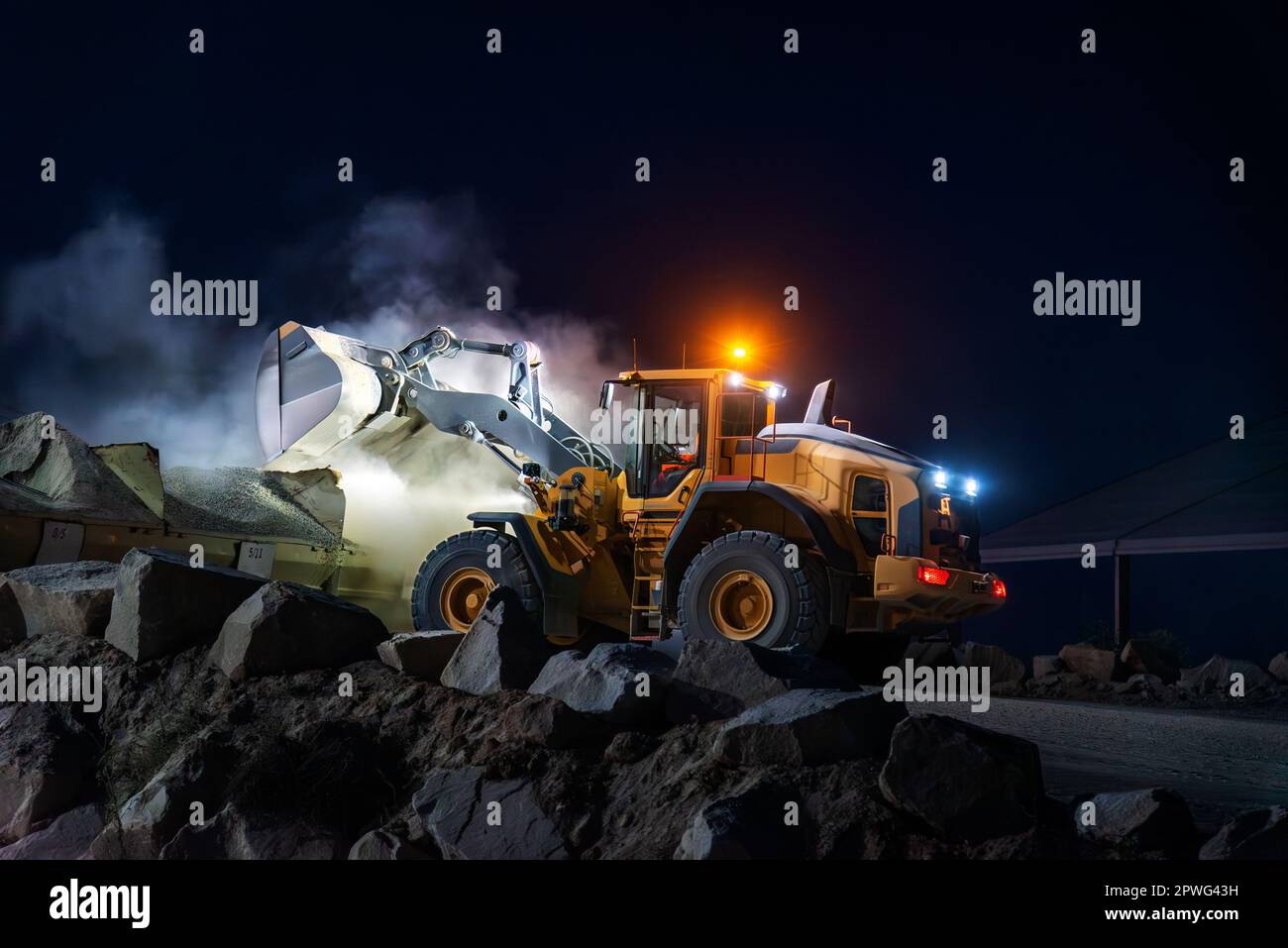 Heavy construction and mining machinery unloading gravel into silos on ...