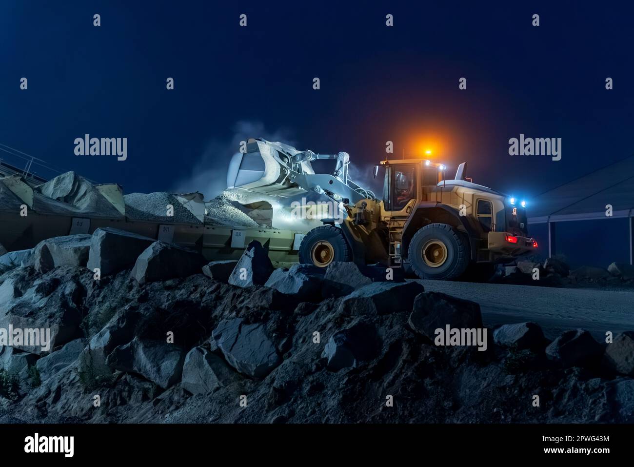 Heavy construction and mining machinery unloading gravel into silos on ...