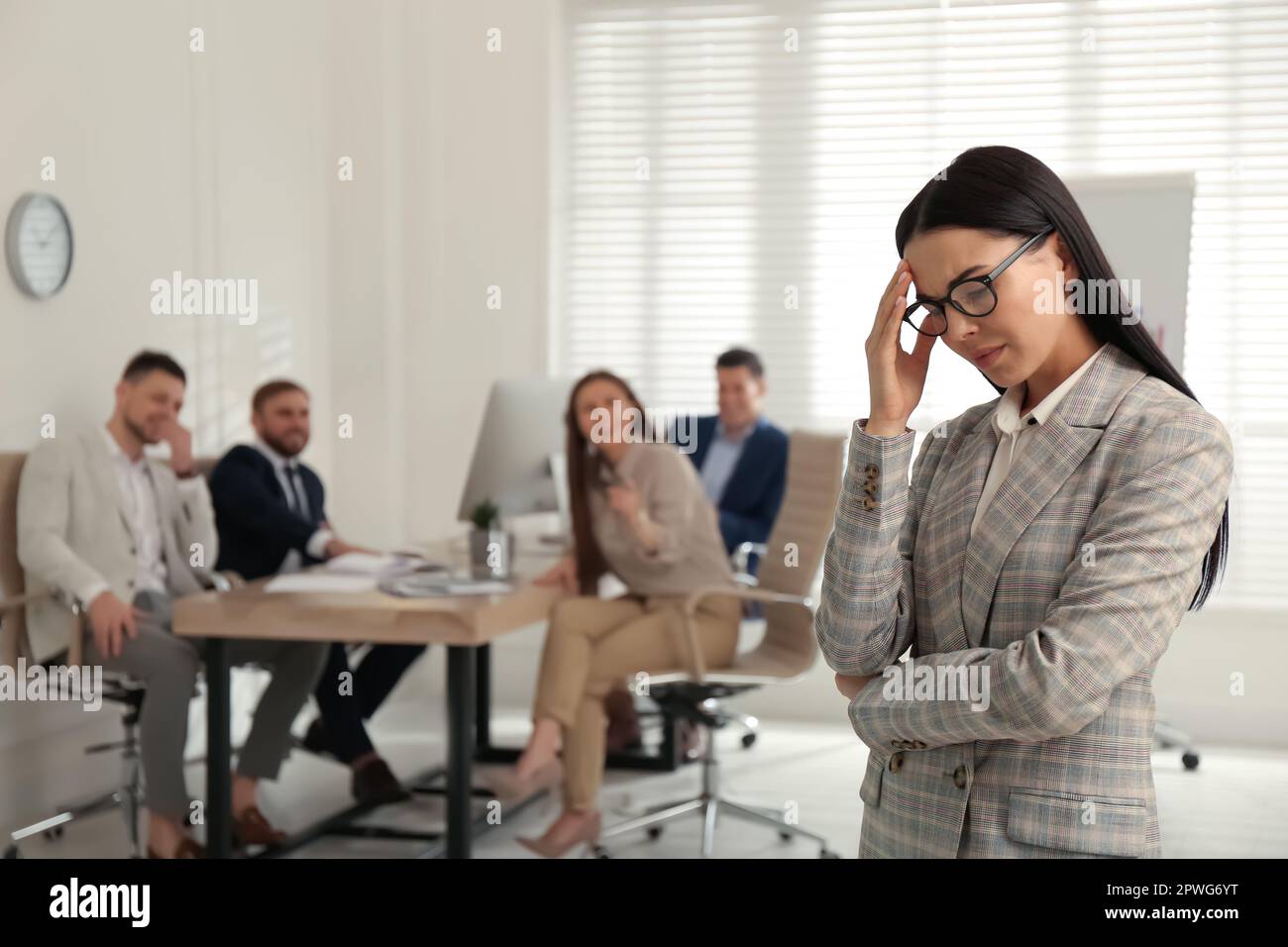 Woman suffering from toxic environment at work Stock Photo - Alamy