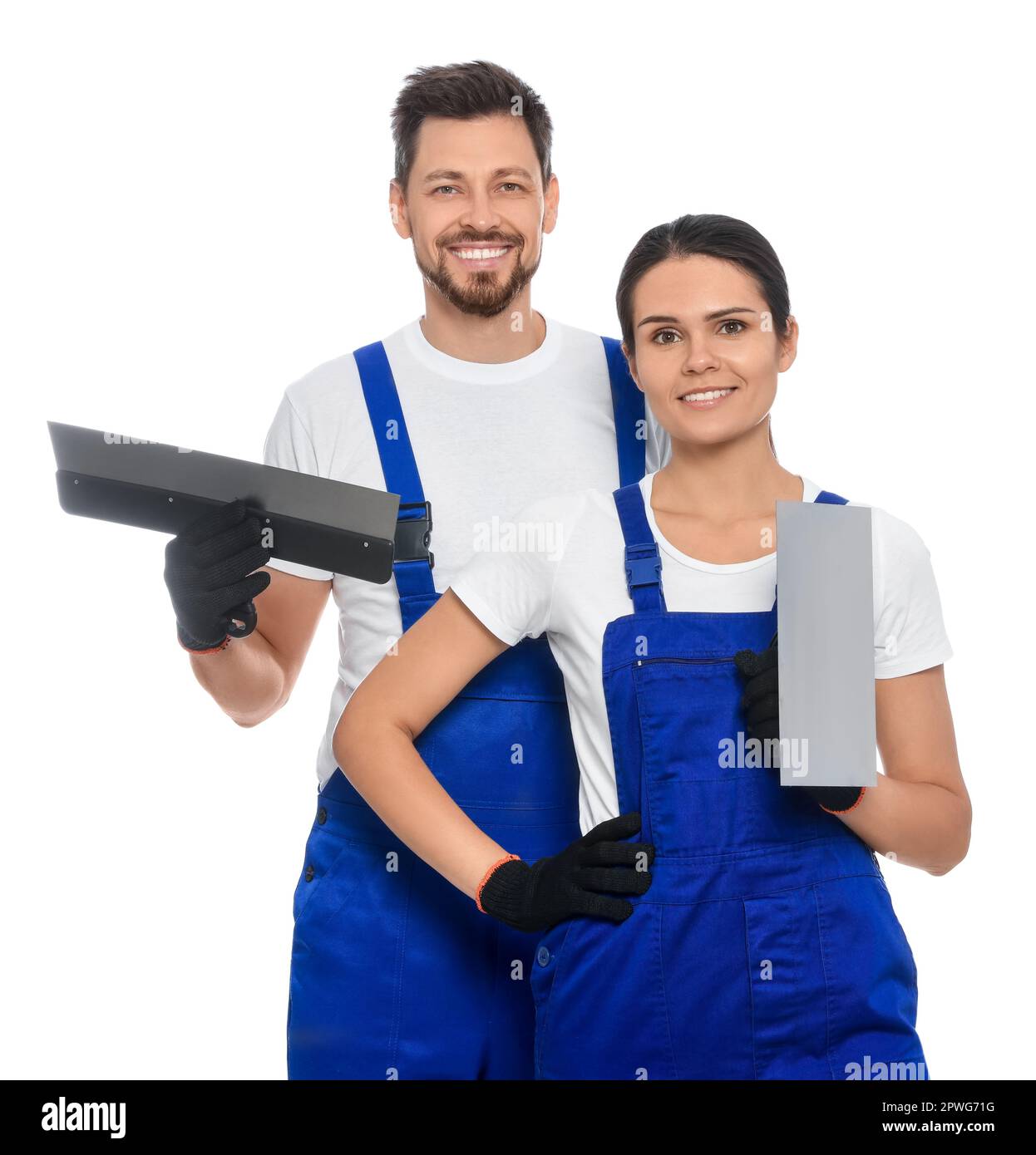 Professional workers in uniform with putty knives on white background ...