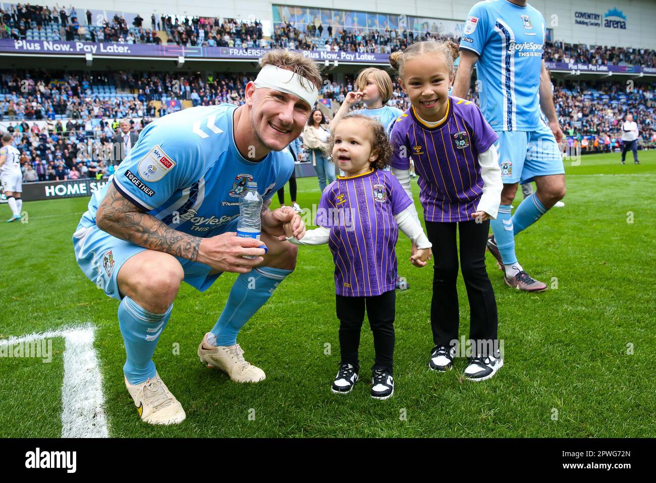 Coventry City's Kyle McFadzean and his family on the pitch at the end ...