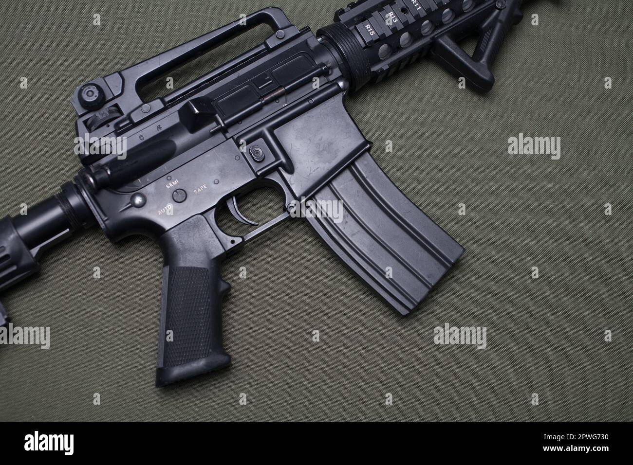 M4 assault rifle on olive drab canvas background Stock Photo - Alamy