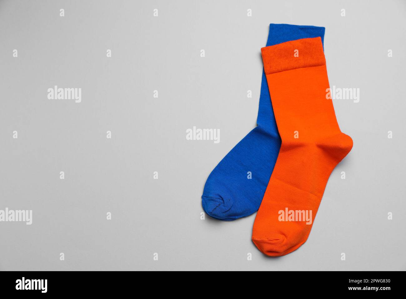 Colorful socks on light grey background, flat lay. Space for text Stock ...