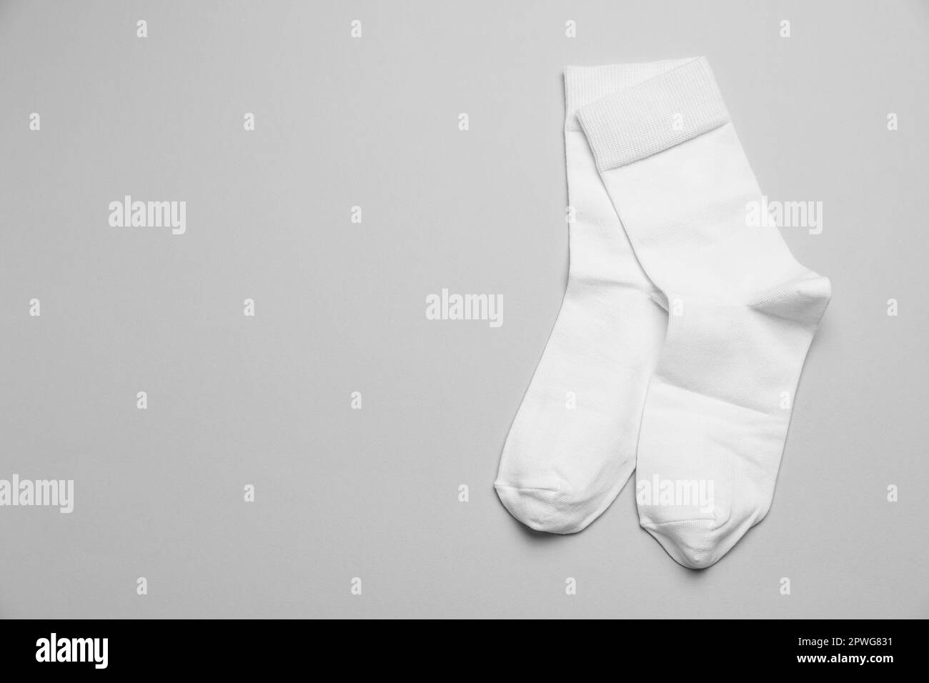 White socks on light grey background, flat lay. Space for text Stock ...