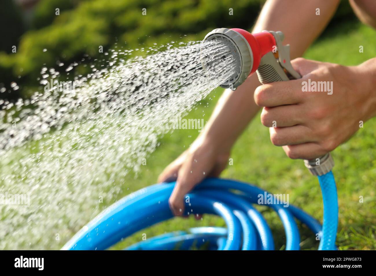 Water spraying from hosepipe sprinkler hi-res stock photography and ...