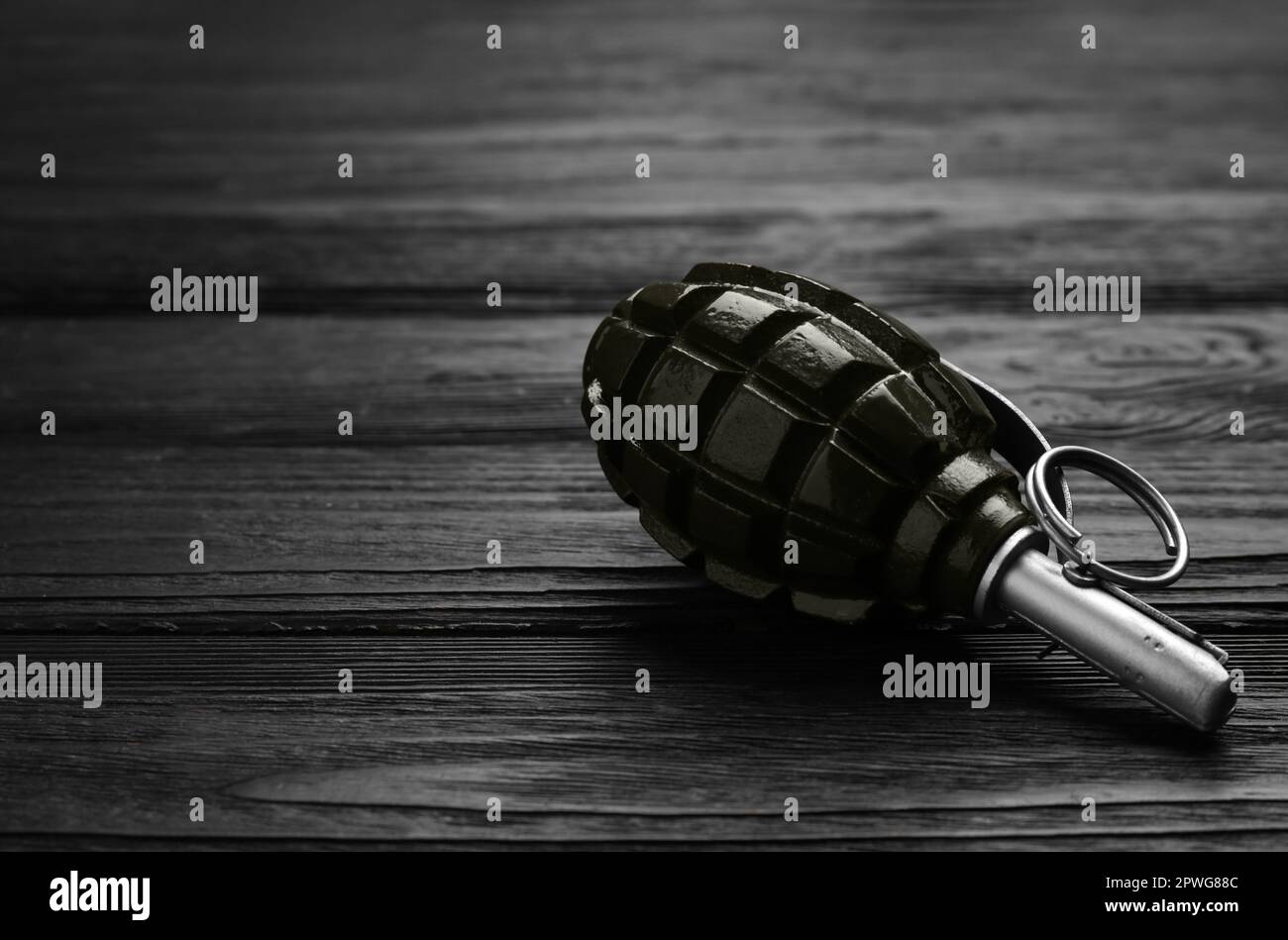 Hand grenade on black wooden table. Space for text Stock Photo - Alamy