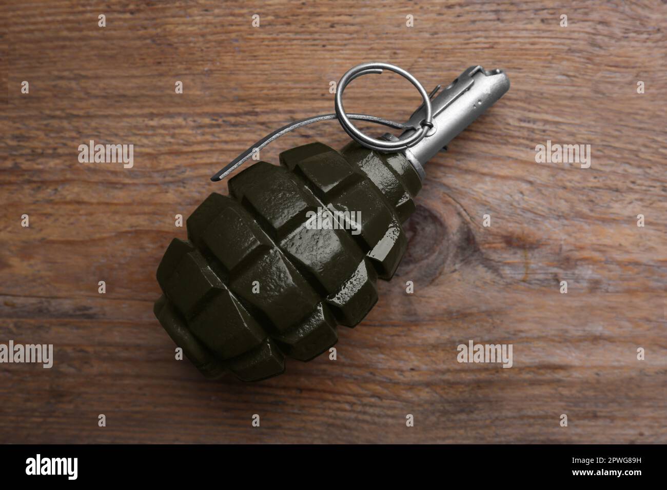 Hand grenade on wooden table, top view Stock Photo - Alamy