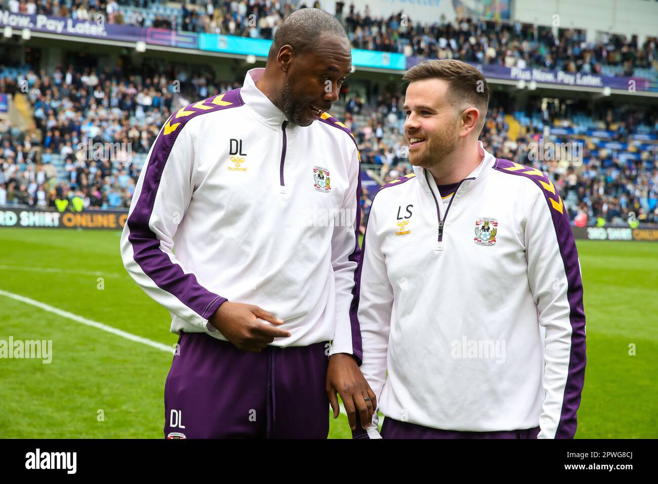 Coventry City first team coach Dennis Lawrence (left) speaks to Liam ...