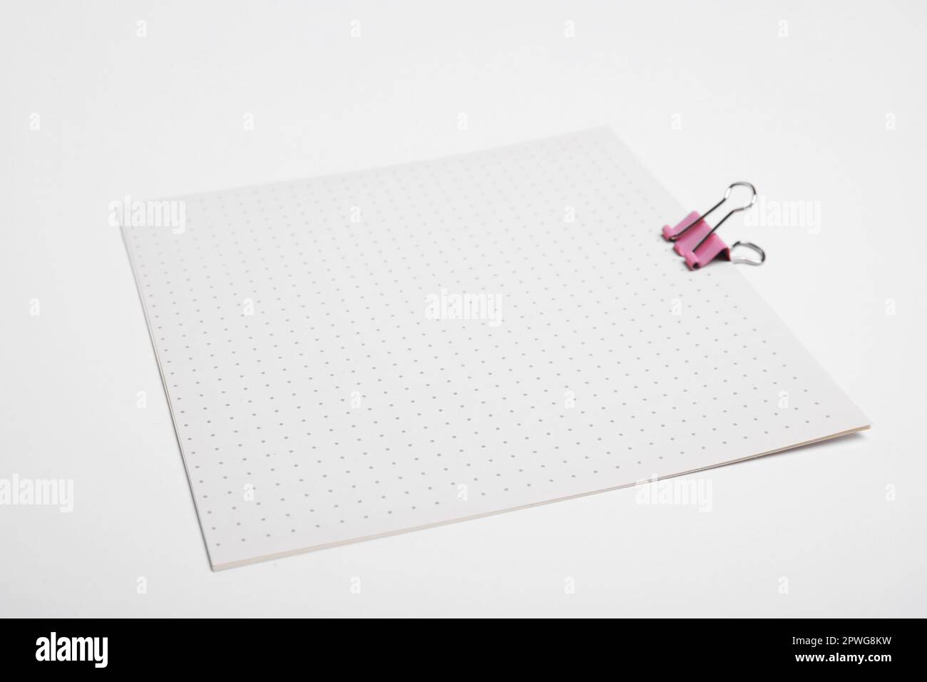 Sheets of paper with clip on white background Stock Photo - Alamy